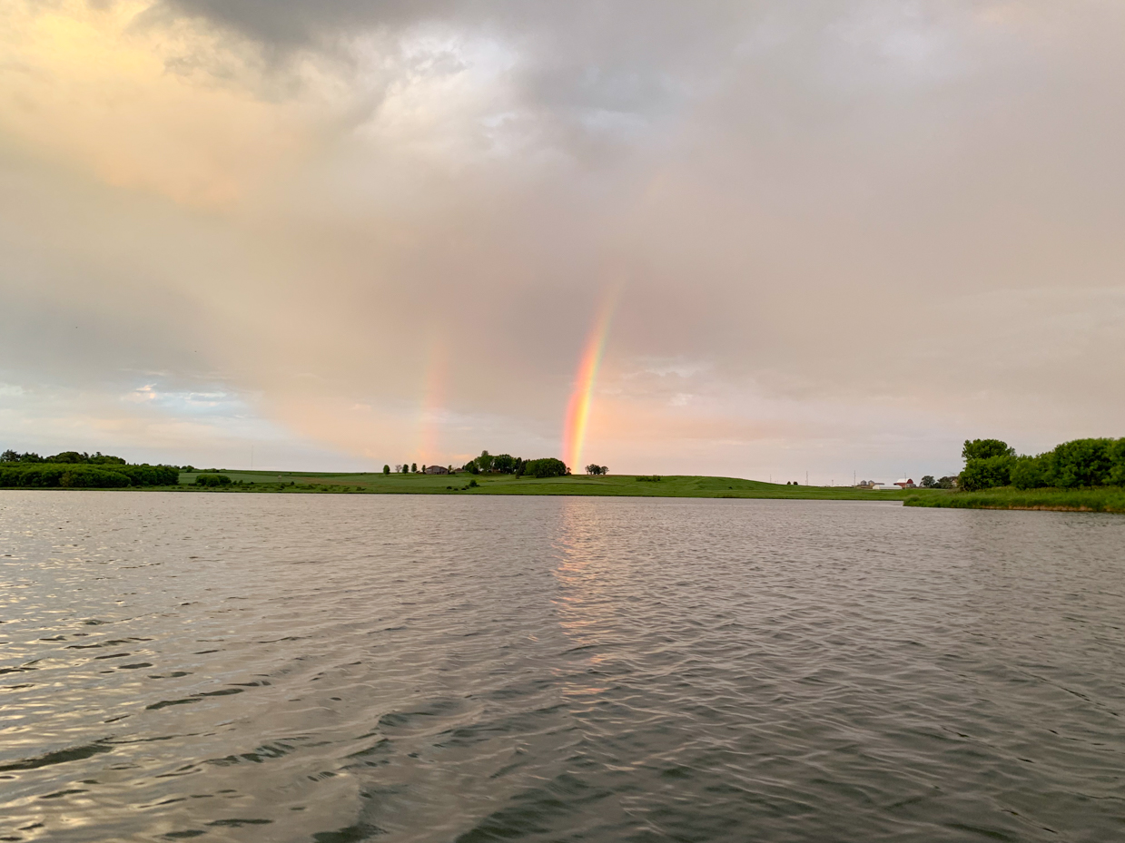 Double Rainbow Reflecting Over a Tranquil Lake at Sunset – Stunning ...